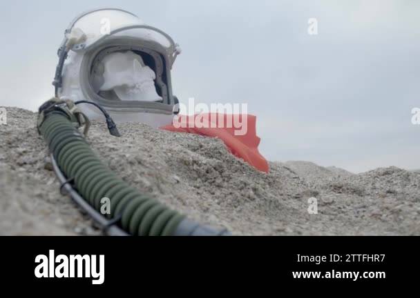 The head of a dead cosmonaut lies on the sand by the sea. Astronaut ...