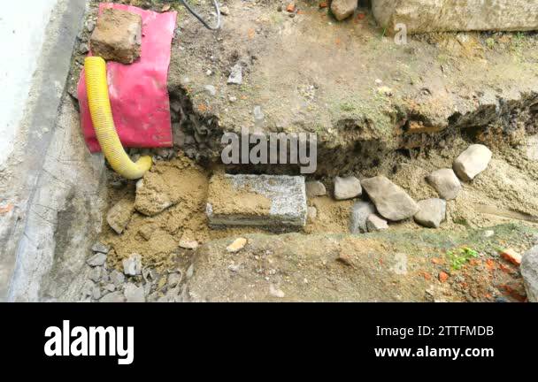 Pouring, laying concrete into foundations of the house using shovel of ...