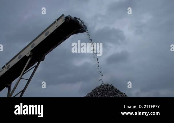 An overview of coal chunks falling from the belt conveyor at the coal ...
