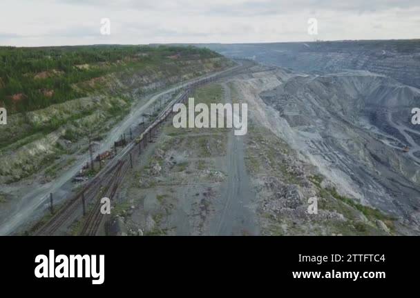 Open-pit mine, mining train carrying excavated materials at the ...