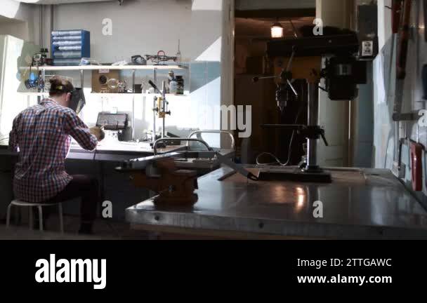 Back view of professional welder man with torch and protective mask ...