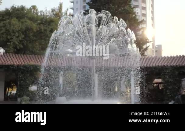 A Fountain Sparkling In The Evening Sun In The City Park. Splash of ...