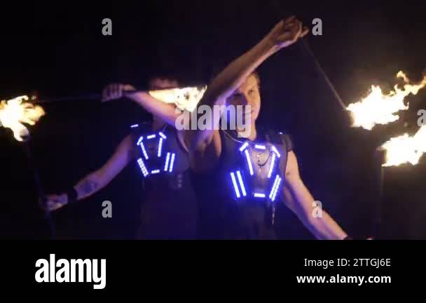 fire show, dancing with flame, a man in a suit LED dances with fire ...