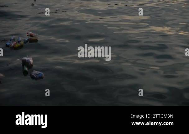 Trash and garbage floating on the surface of the water. Water pollution ...