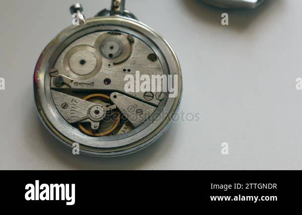 Watchmaking is a master at work. Disassembles the clock using a ...