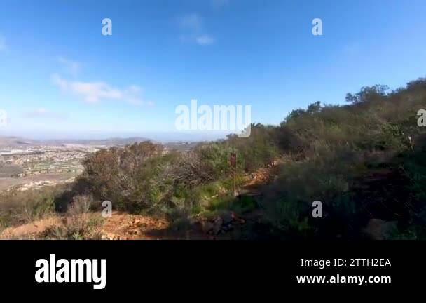 Walking through small trails to the top of the Black Mountain in San ...