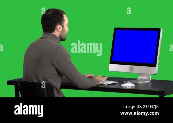 Businessman working with a computer on a Green Screen, Chroma Key. Blue ...