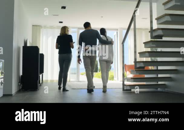 Professional Real Estate Agent Shows Stylish Modern House to a ...