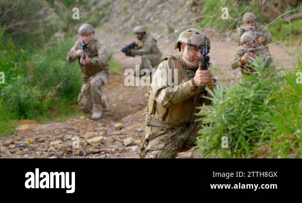 Front view of mixed-race military soldiers rifle training in fields ...