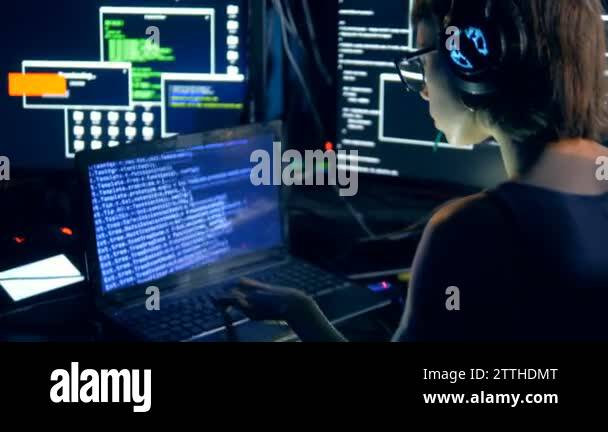 Girl types on a laptop, hacking system. Cyber crime and hacking concept ...