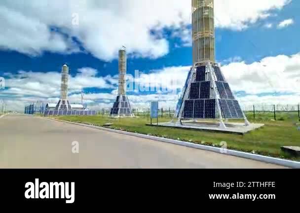 Solar Panel towers on solar plant with High Voltage Tower in Background ...