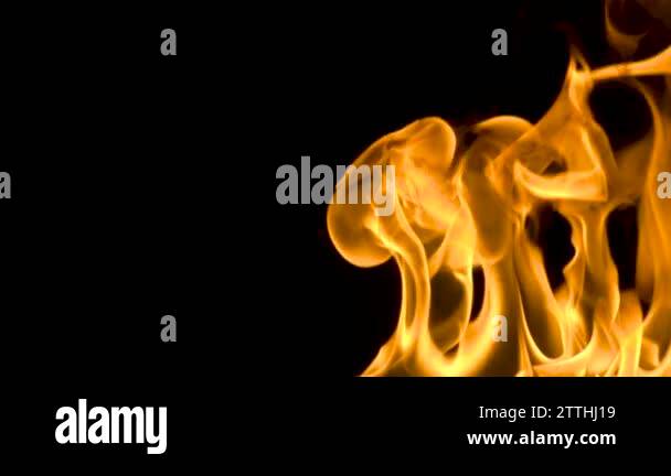 Fire and flames burning on a reflective glass surface, in slow motion ...
