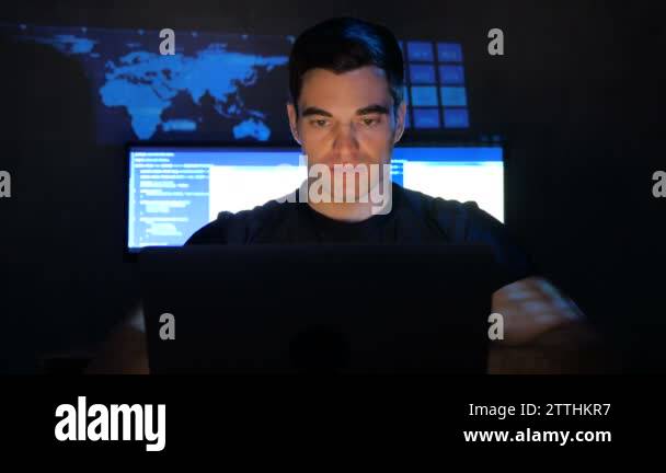 close up portrait of developer programmer looks at camera in a data ...