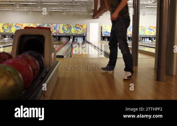 People playing a game of bowling at the small town bowling alley Stock ...
