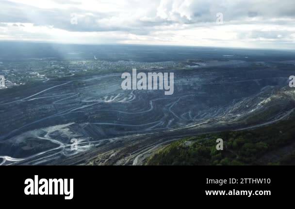 Coal mining at an open pit. Top view of the quarry. Dozers and trucks ...