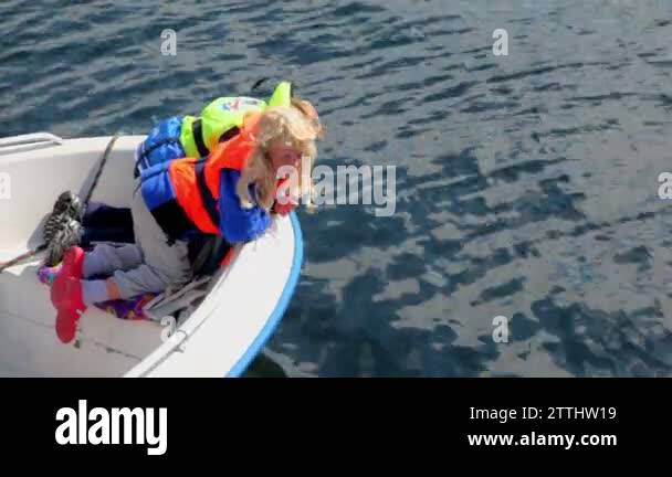 Parents with kids float on boat with engine, woman show fish Stock ...