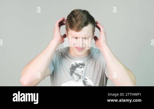 young, angry, unhappy, stressed man covering his ears, to say, stop ...