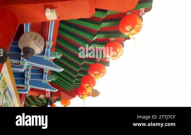 A row of red lantern hanging off a buddhist temple architecture. The ...