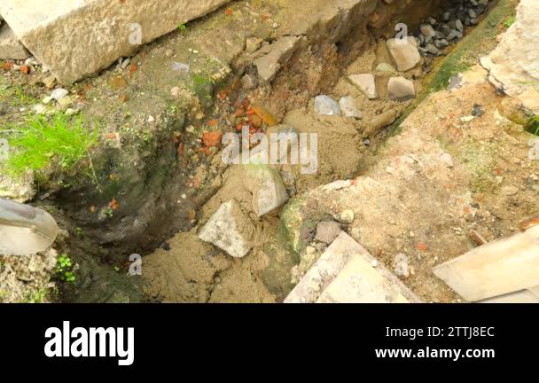 Pouring, laying concrete into foundations of the house using shovel of ...