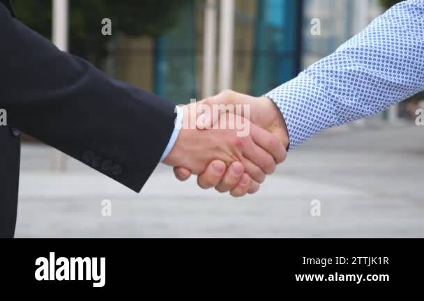 Two businessmen greeting each other in urban environment. Business ...