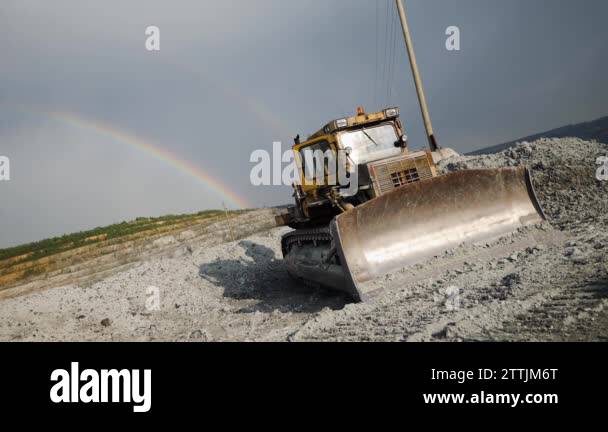 Bulldozer in background of open pit. Bulldozer stands motionless on ...