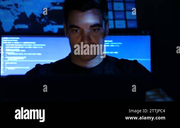 close-up portrait of developer programmer looks at camera in a data ...