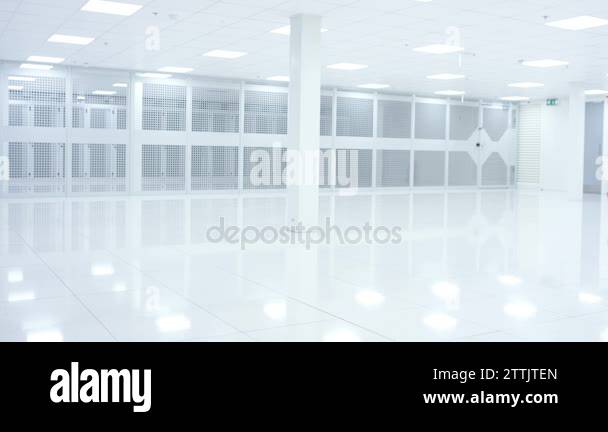 Empty interior of large modern data centre with rows of server racks ...
