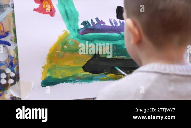 Young Hands of the Artist, Little child Artist Paints a Canvas with ...