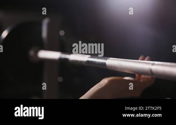 Inflated strong man with big muscles raises the bar lying on the bench ...