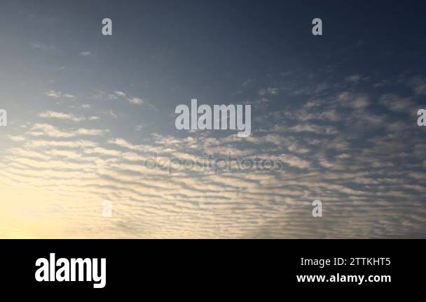 White clouds disappear in the hot sun on blue sky. Time-lapse motion ...