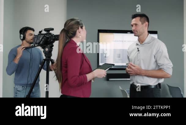 Happy businessman during corporate interview with female journalist ...