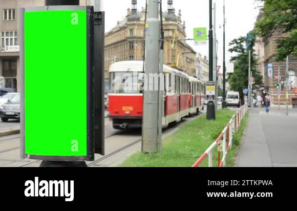 Billboard - green screen - urban street with passing cars and trams and ...