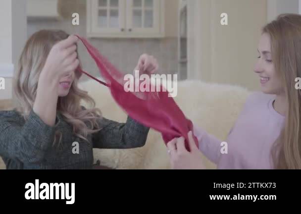 Happy cute young girl shows off her just now bought nightie to her ...