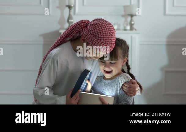 Little Muslim girl presenting a gift box to little muslim boy ...