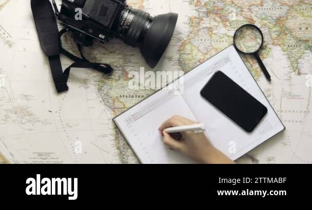 Tourist woman looking at world map planning travel adventure. top view ...