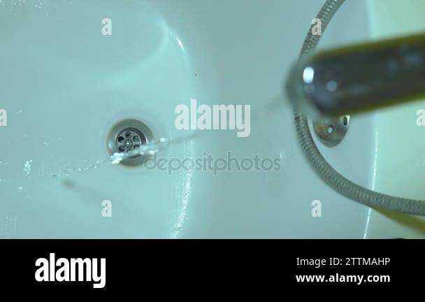 Pour water into the bath With a strong flow of water from the tap, the ...