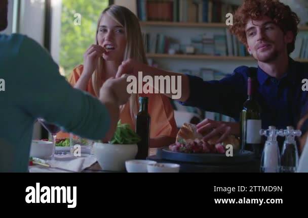 People drinking, eating and talking.Four caucasian friends man and ...