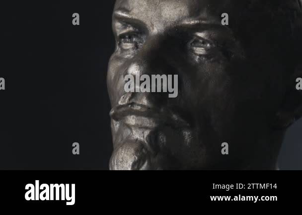 Spinning portrait sculpture of Vladimir Lenin on black background. Era ...