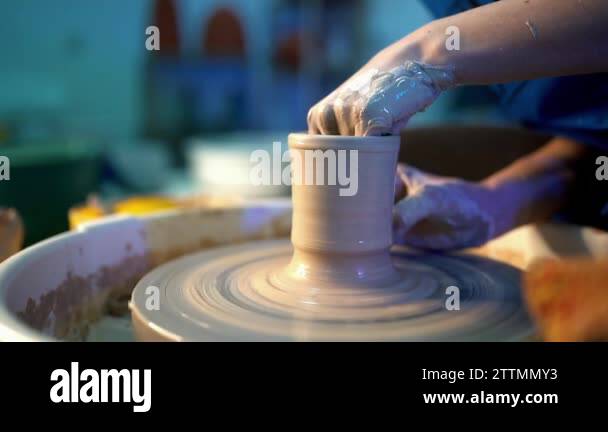 Traditional pottery making, man teacher shows the basics of pottery in ...
