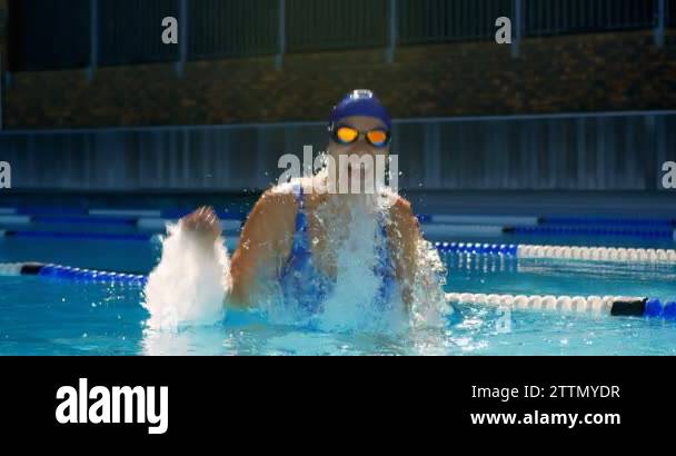 Excited female swimmer cheering in swimming pool. Happy female swimmer ...