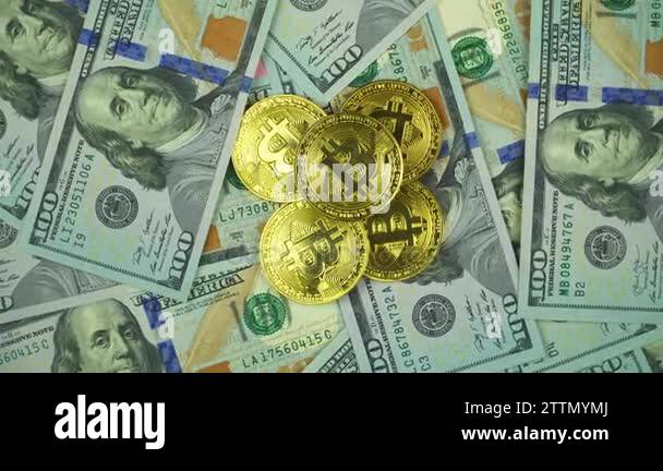 Gold Bit Coin BTC coins rotating on bills of 100 dollars. Worldwide ...