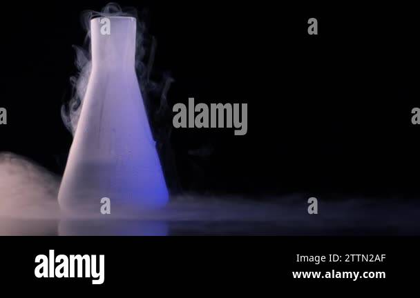 Flask with liquid nitrogen on black background. Concept of chemical ...