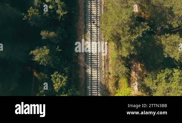 Drone top view of man running on train track. Concept of life never ...