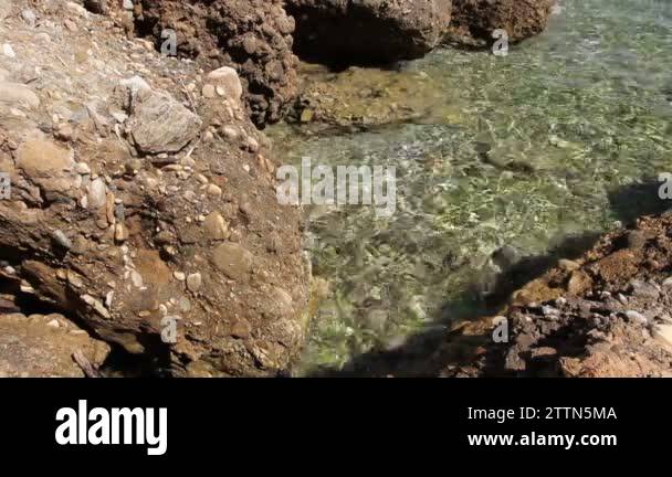 Rock is sticking out above the shoal water, above the sea level Stock ...