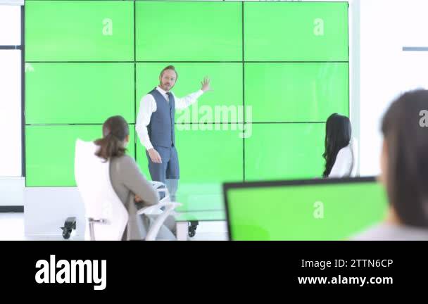 4K Business team in a meeting, man interacting with green screen video ...