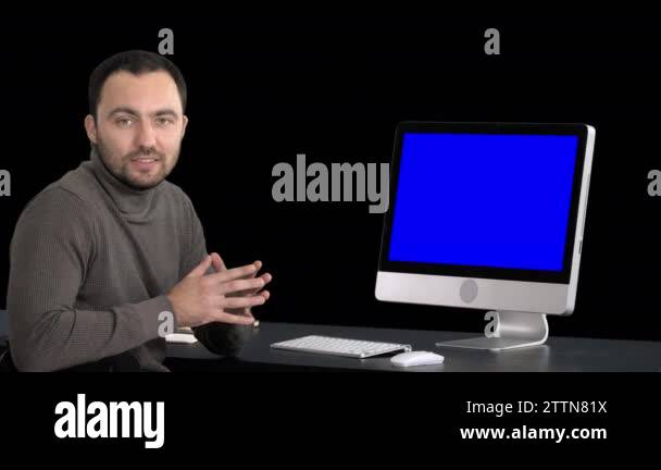 Casual businessman smiling and talking at the camera showing something ...