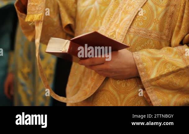 Priest beginning divine liturgy, crossing himself and praying god for ...
