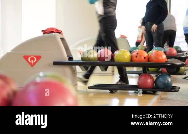 People playing a game of bowling at the small town bowling alley Stock ...