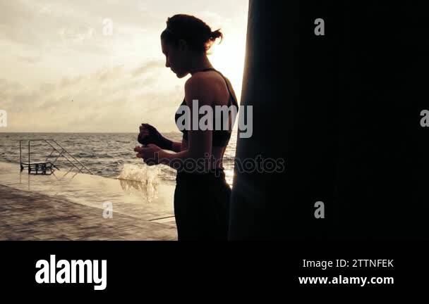 Female boxer getting her fists ready for the boxing gloves by wrapping ...