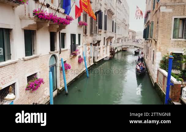 Venice, Italy, June 2017: Gondolas with tourists swim in a narrow canal ...